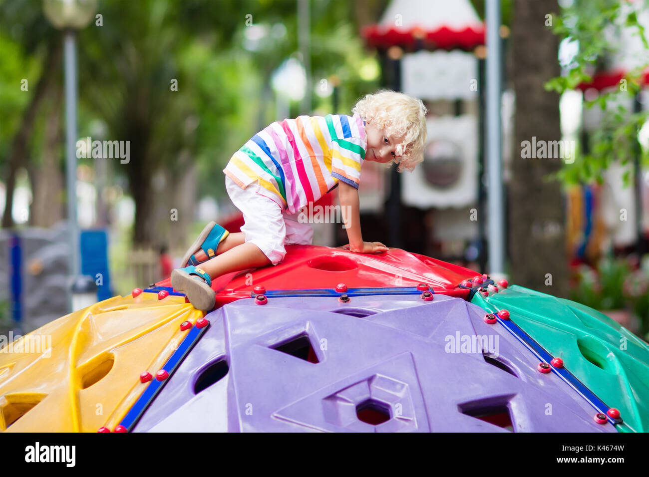 Kids on playground. Children play in summer park. Child on slide and ...