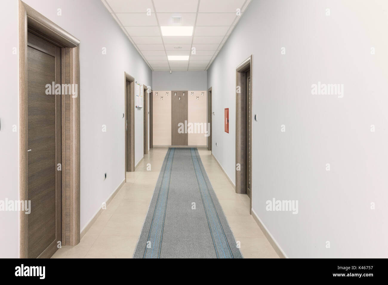 hallway with many wooden doors Stock Photo - Alamy