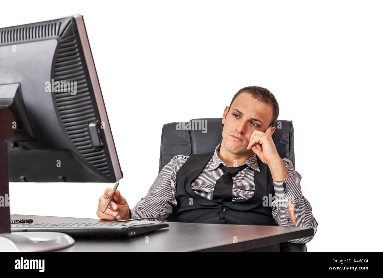 Tired businessman in front of his computer at the workplace isolated ...