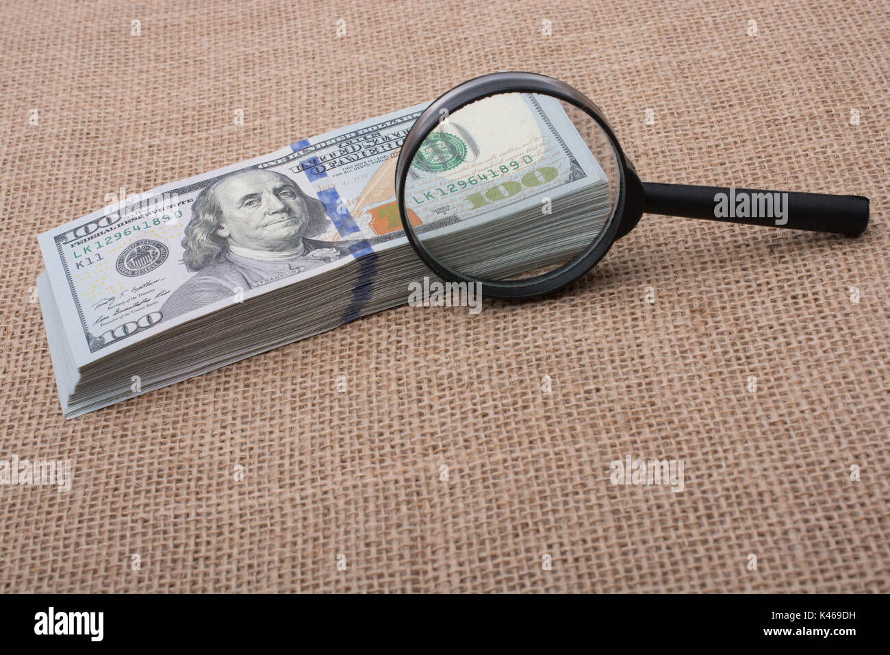 Magnifying glass over the banknote bundle of US dollar Stock Photo - Alamy