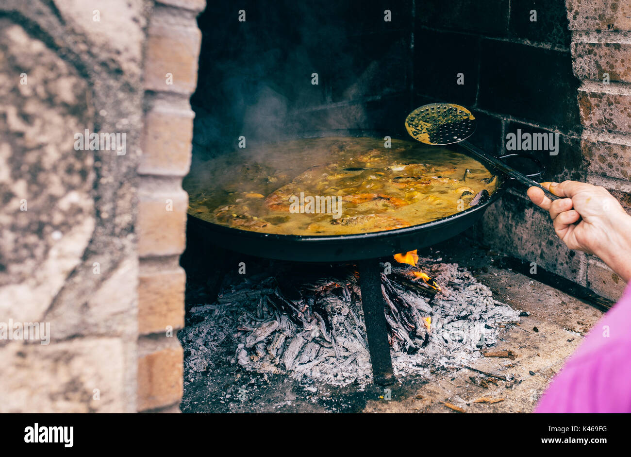 Typical spanish paella in the fire Stock Photo - Alamy