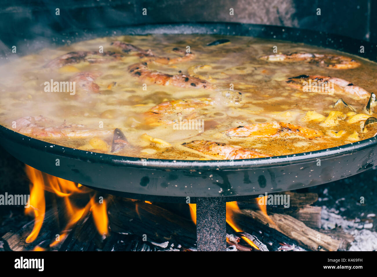 Typical spanish paella in the fire Stock Photo - Alamy