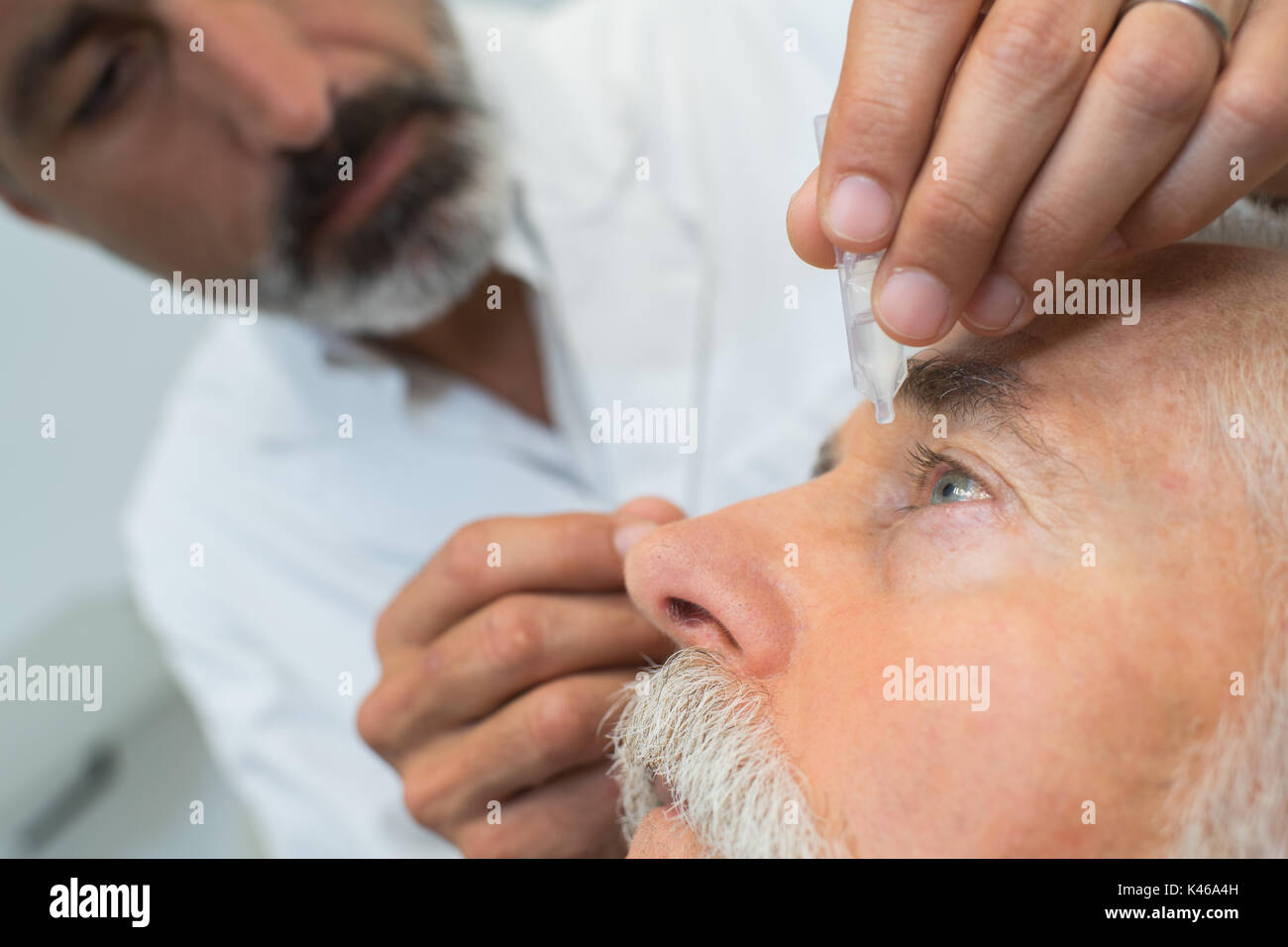 eye while doctor applying eye drop Stock Photo - Alamy