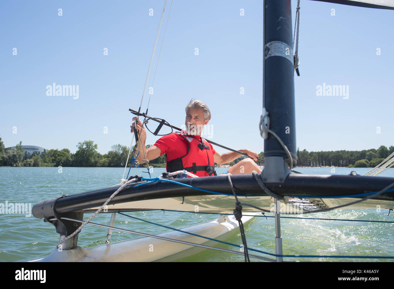 man sailing with sails out on a sunny day Stock Photo - Alamy