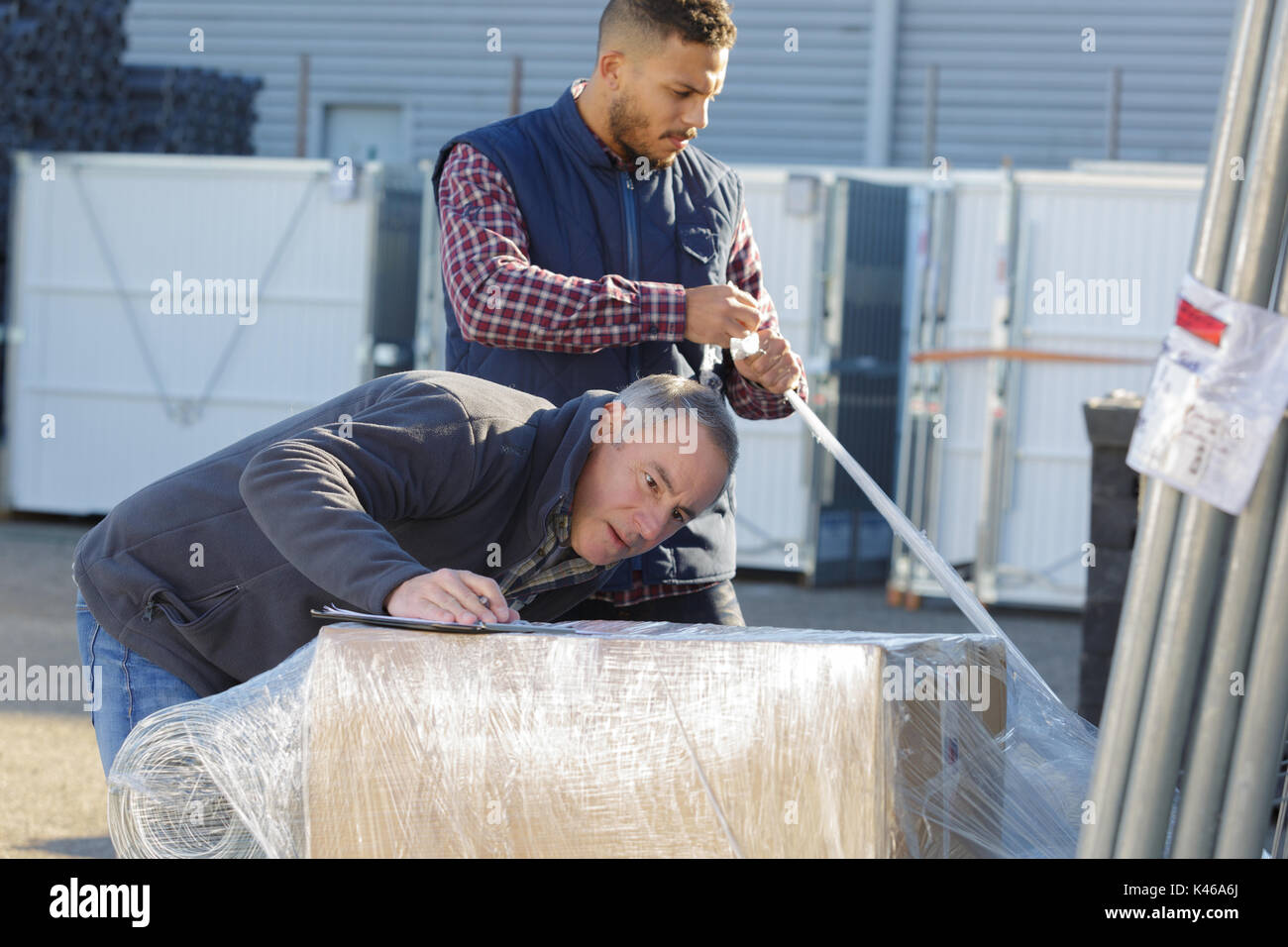 man checking goods in his list at a port Stock Photo - Alamy
