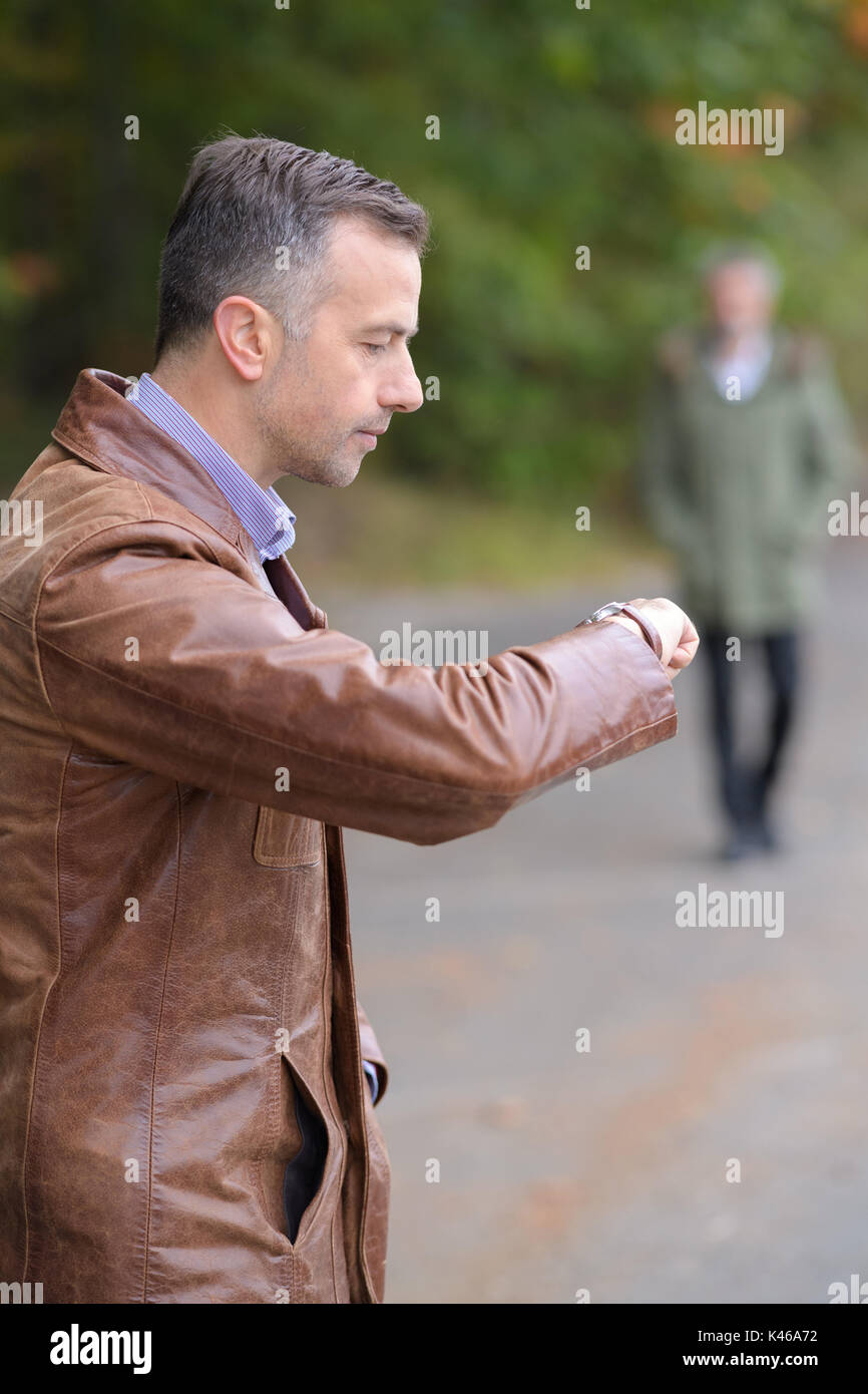 business man watching his wrist watch Stock Photo - Alamy