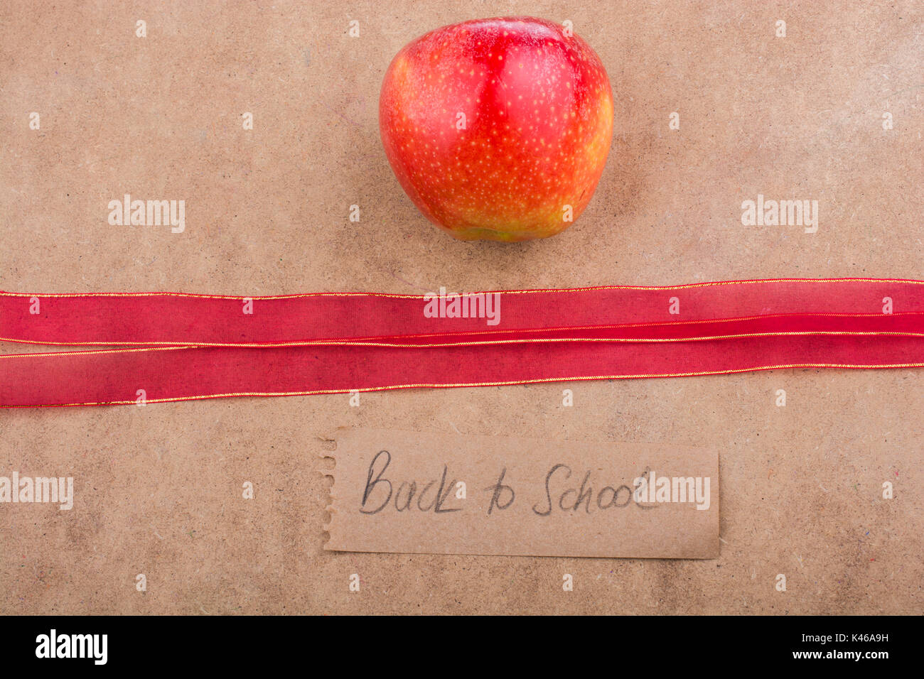 Back to school lettering with apple and a red ribbon Stock Photo - Alamy