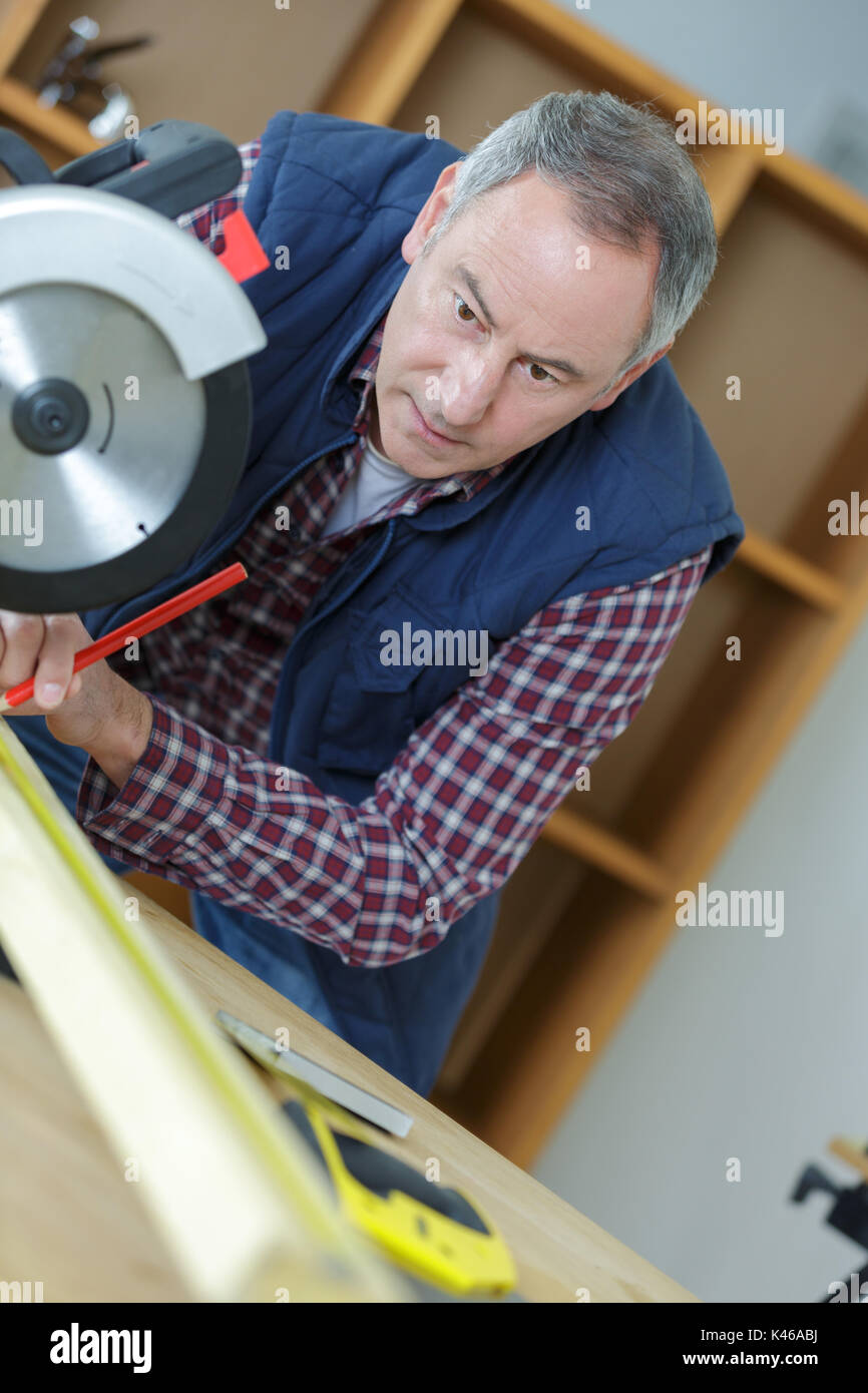 worker in a carpenters workshop using saw machine Stock Photo - Alamy