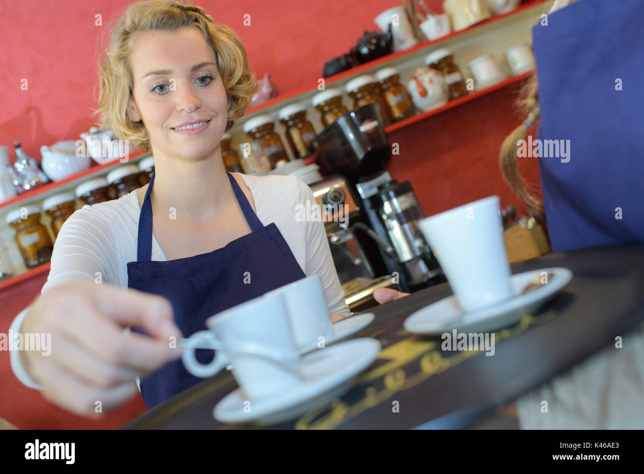 woman serving tea at a coffee shop Stock Photo - Alamy