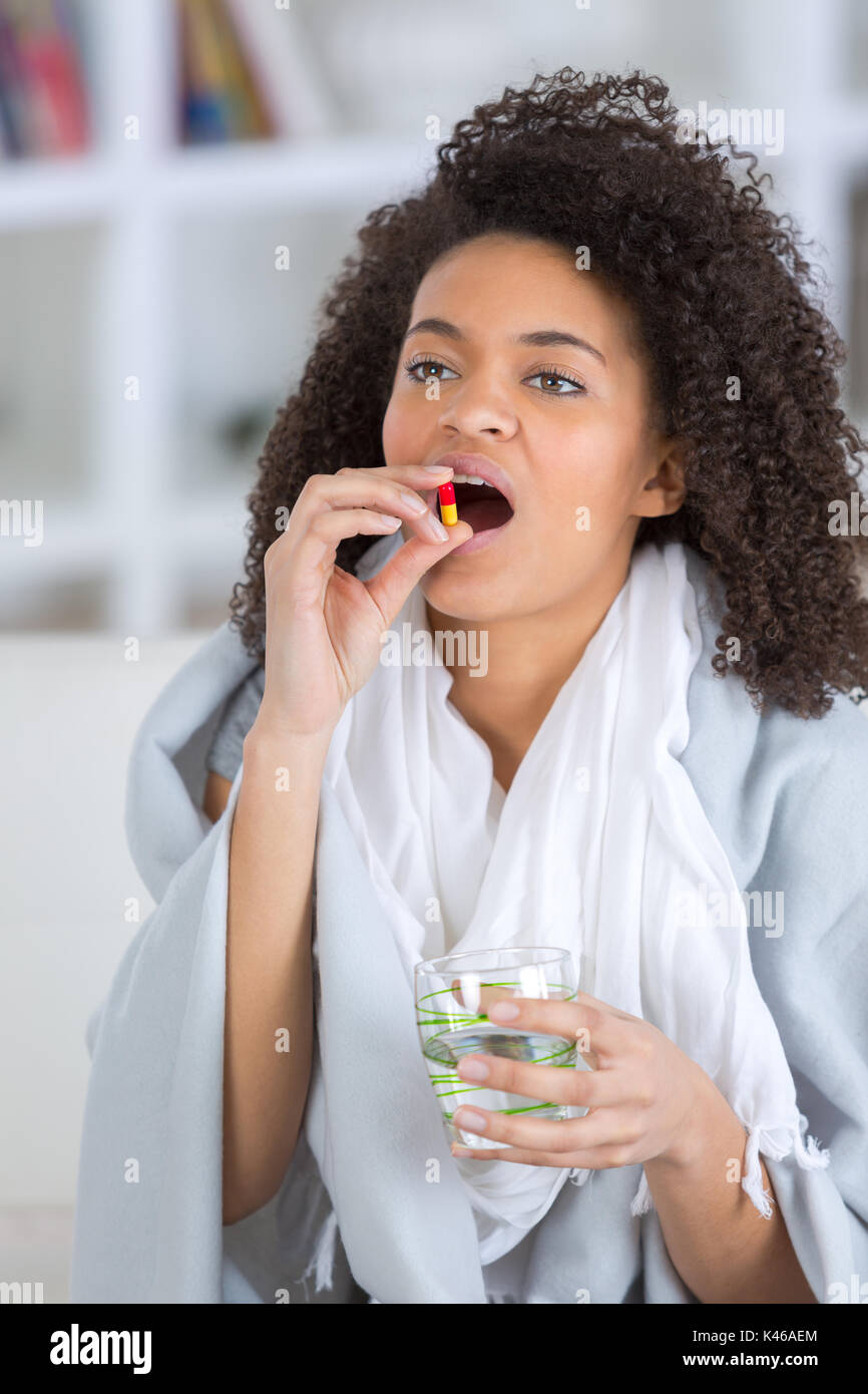 young healthy woman taking a pill Stock Photo - Alamy