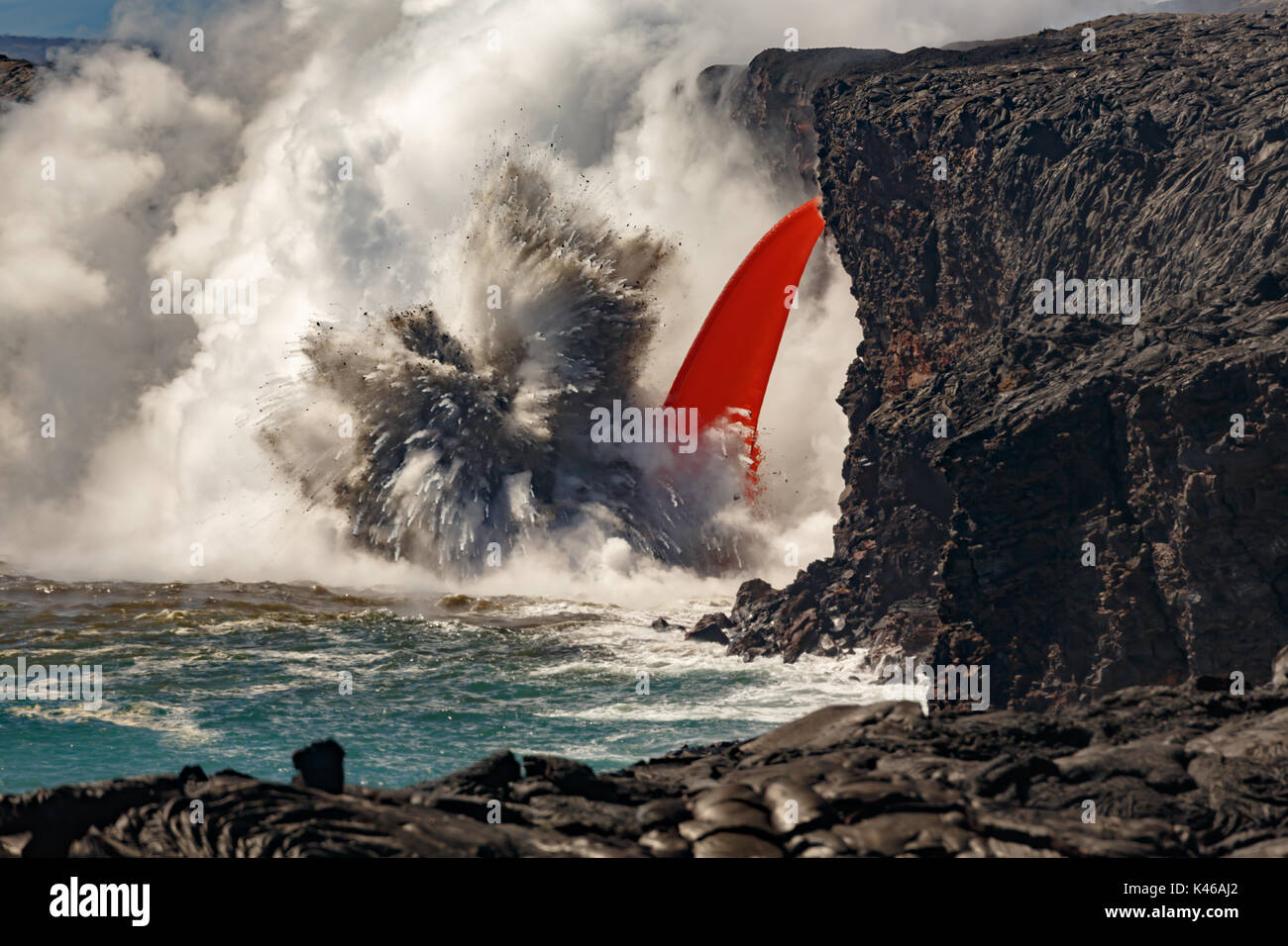 Aerial daytime view of wide waterfall shaped flow of red lava from ...