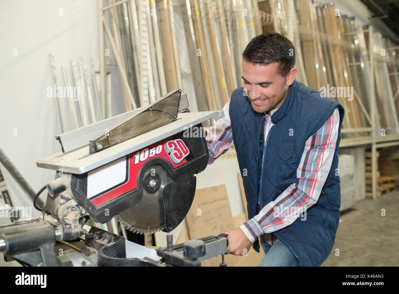 happy man using a sawing a circular saw Stock Photo - Alamy