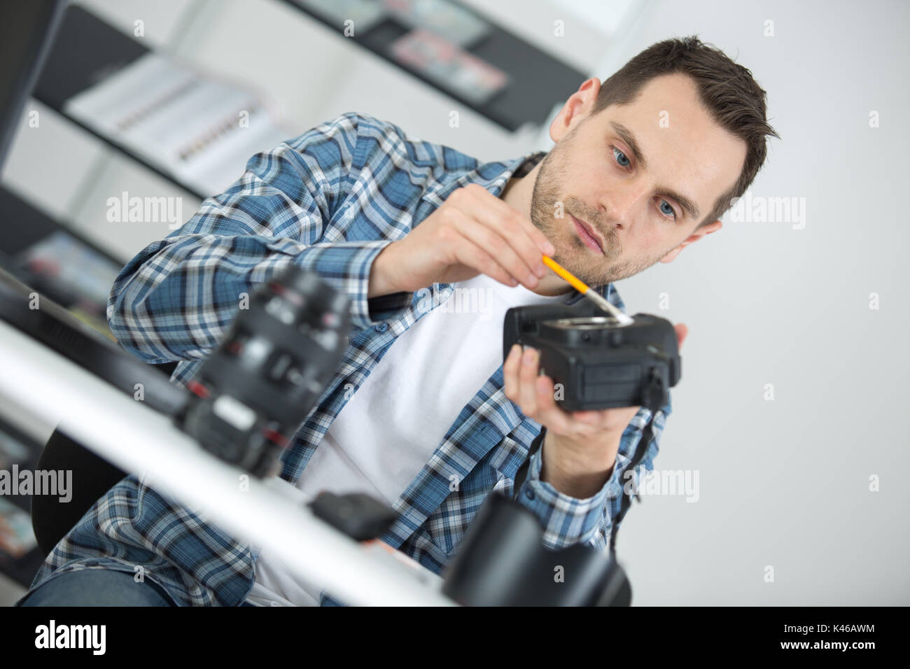 man cleaning camera Stock Photo - Alamy