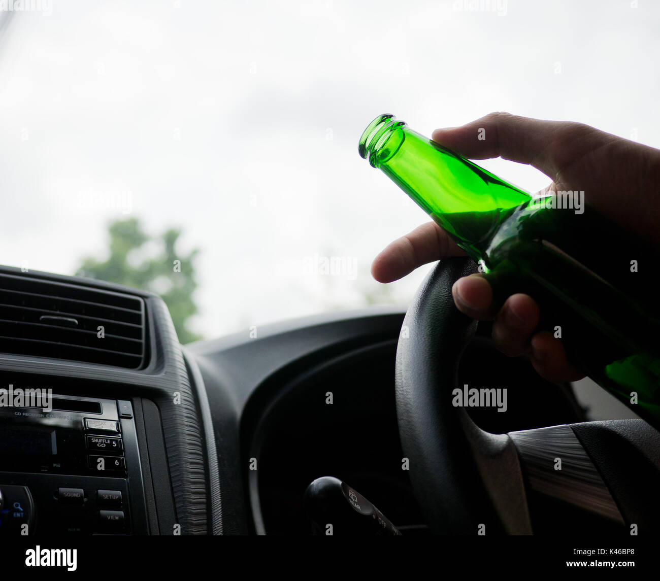 Man drink beer while driving car. Driving in a state of intoxication ...