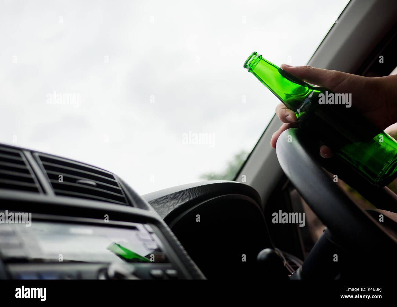 Man drink beer while driving car. Driving in a state of intoxication ...