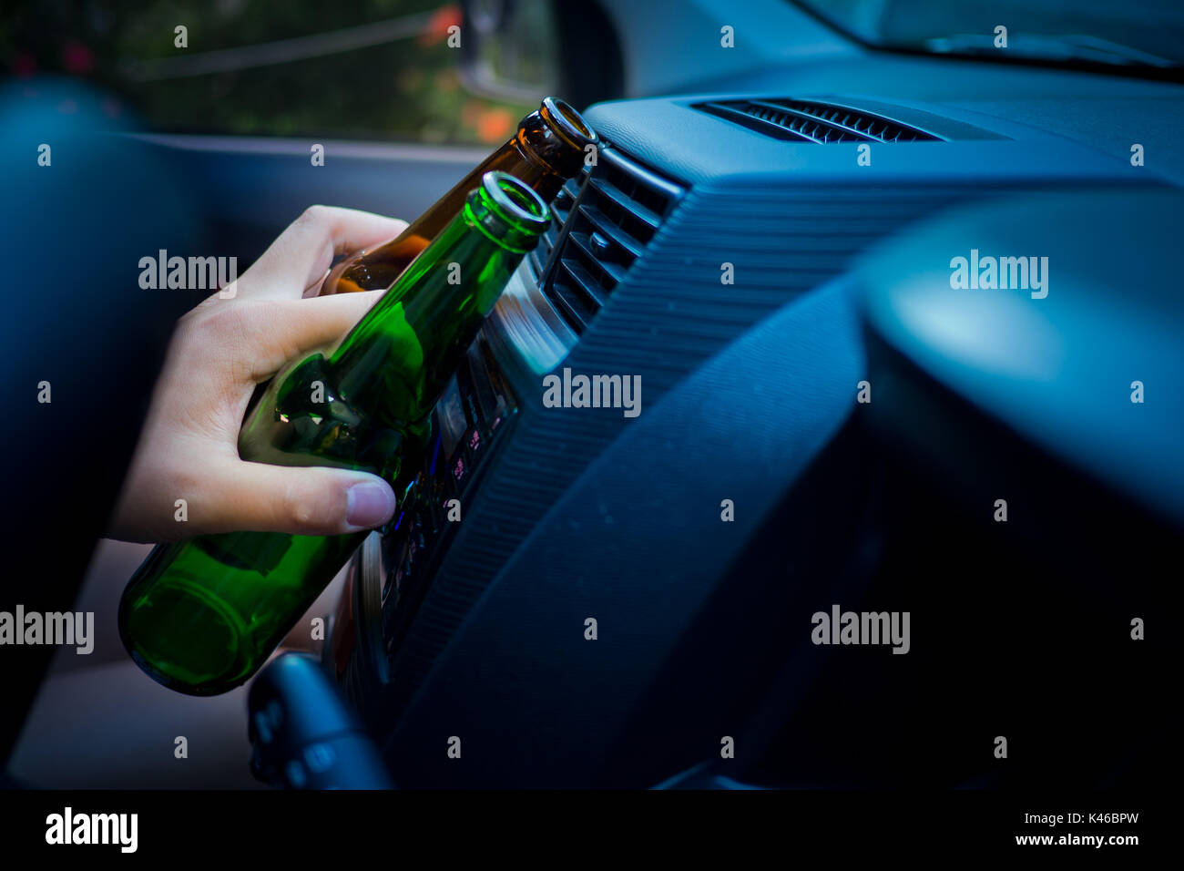 Man drink beer while driving car. Driving in a state of intoxication ...
