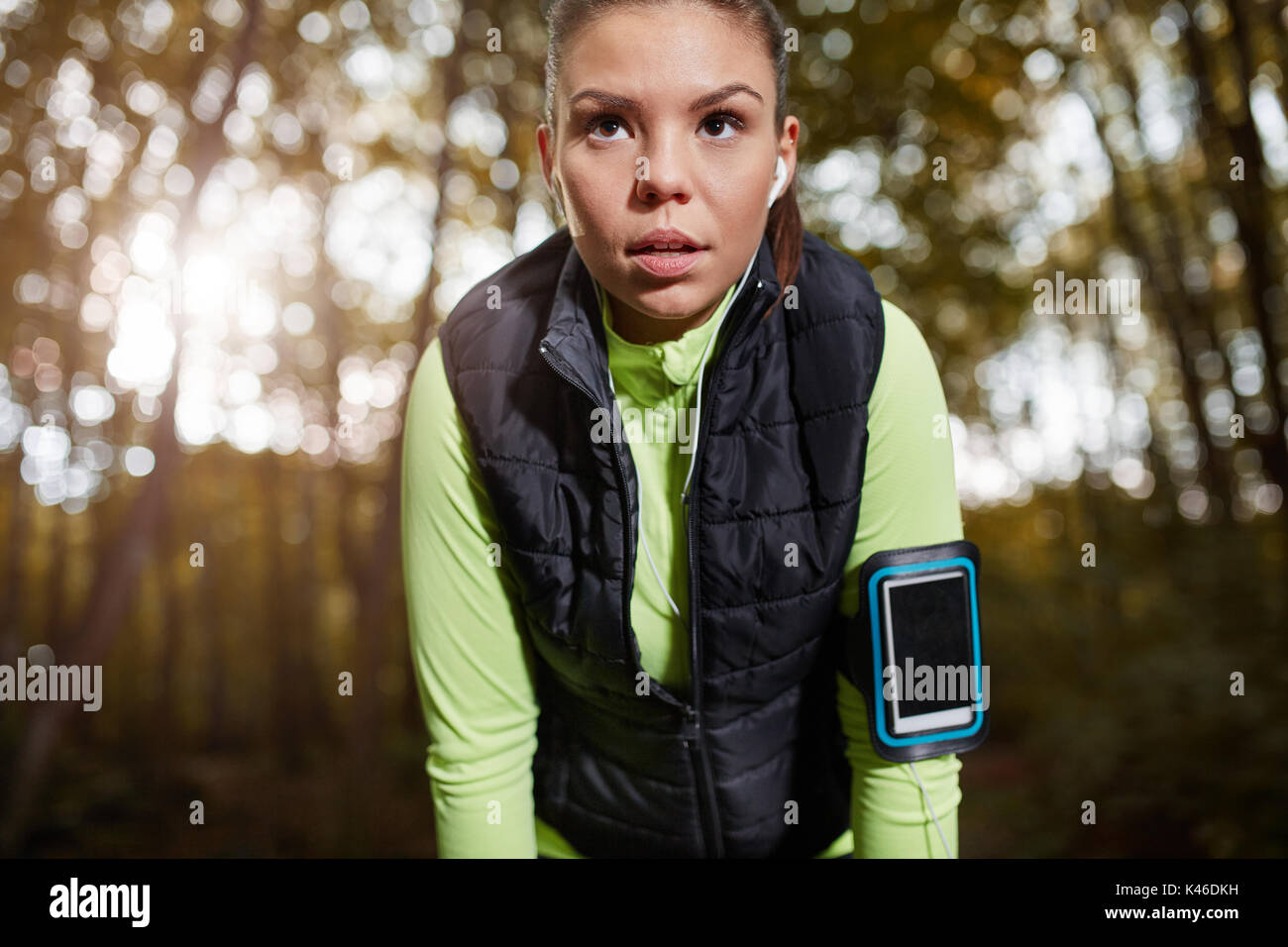 Closeup portrait of sportswoman during jogging bending forwards Stock ...