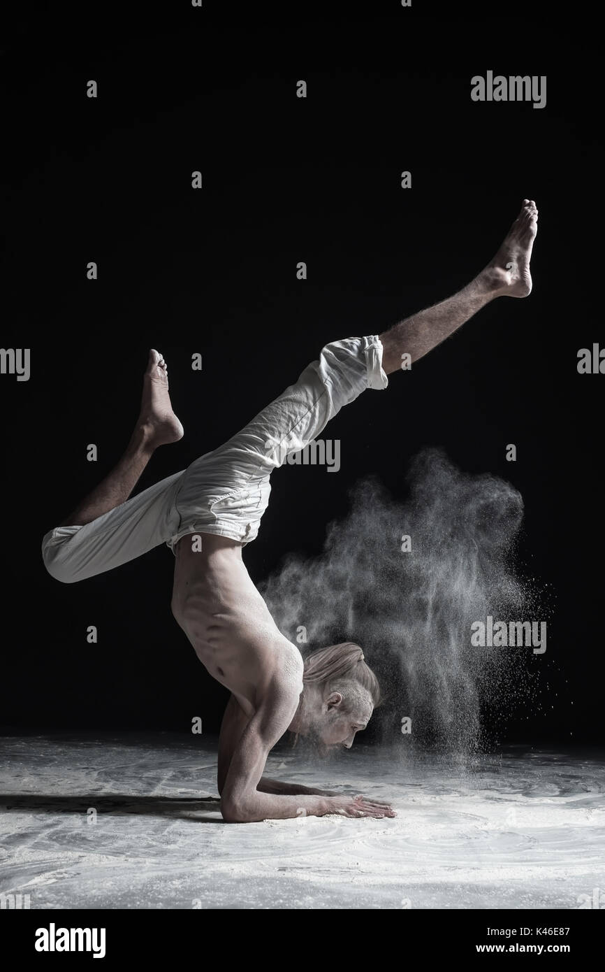 Flexible yoga man doing hand balance asana vrischikasana Stock Photo ...