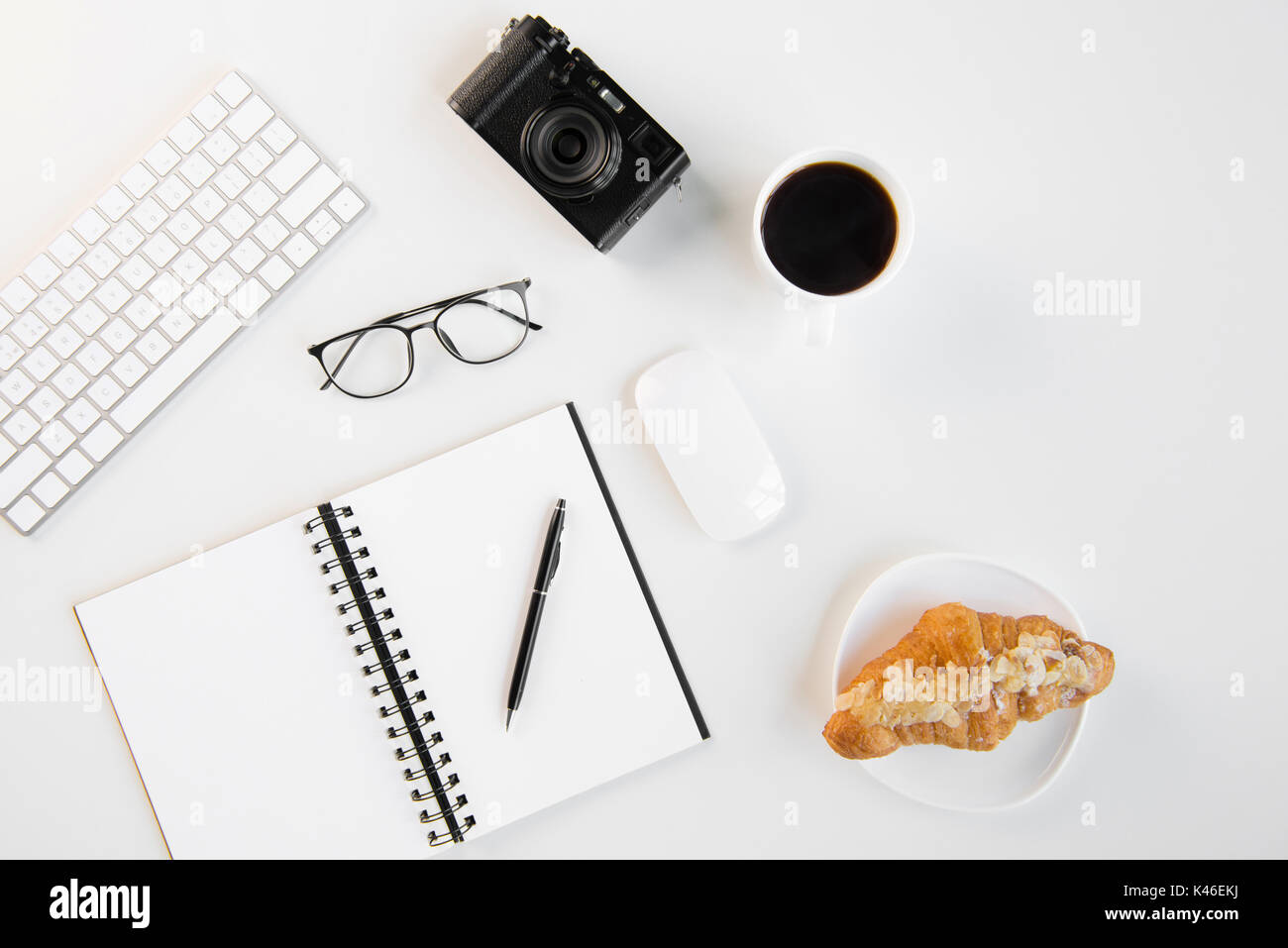 Top view of keyboard, computer mouse, eyeglasses, camera, blank ...