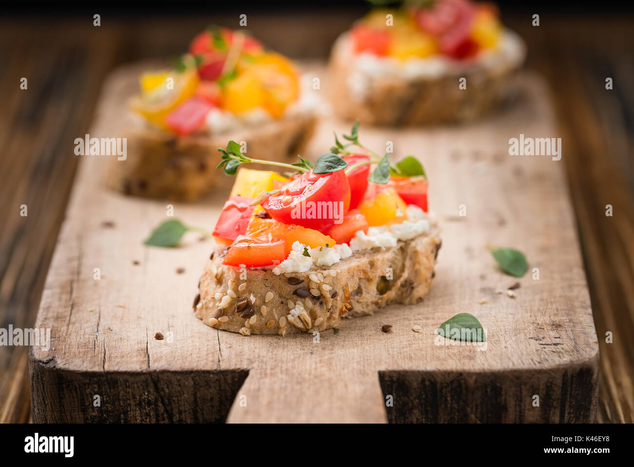 Traditional Italian appetizer, bruschetta with cottage cheese, cherry ...