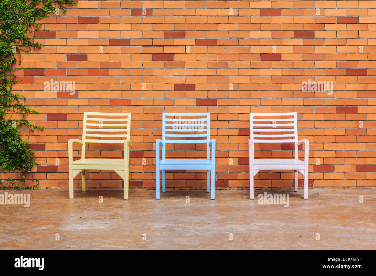 Chairs on grey wall hi-res stock photography and images - Alamy