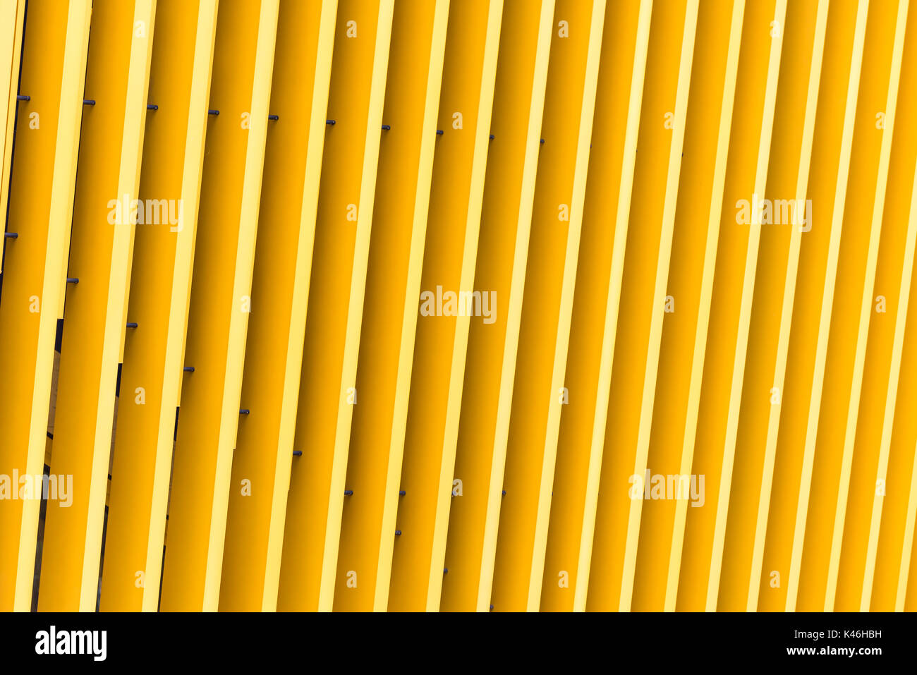 Detail of bright yellow metal building facade. For background Stock ...