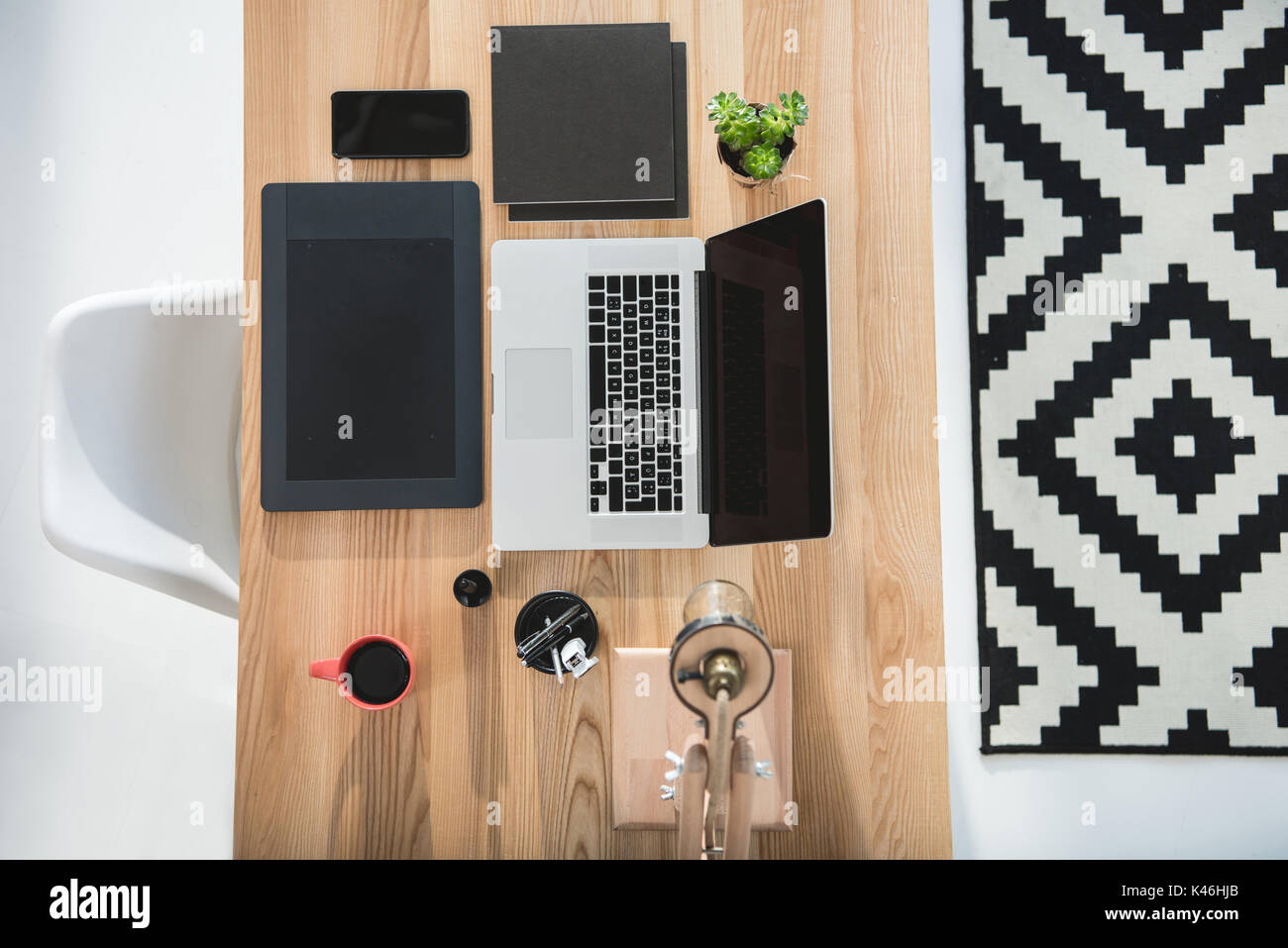 top view of laptop with graphics tablet and smartphone on wooden ...