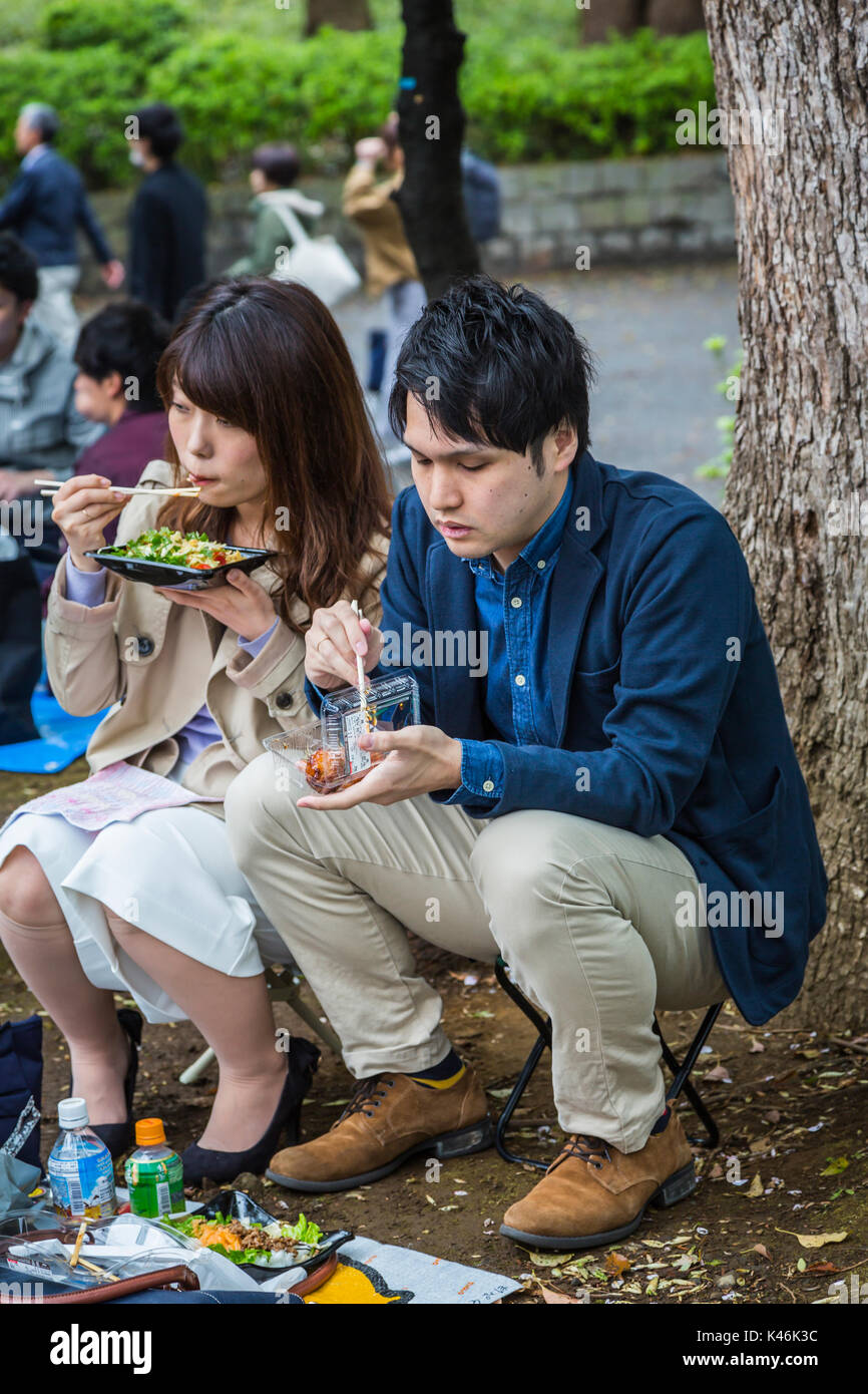 A Japanese couple having a picnic in Ueno Onshi Park, Taito, Tokyo ...