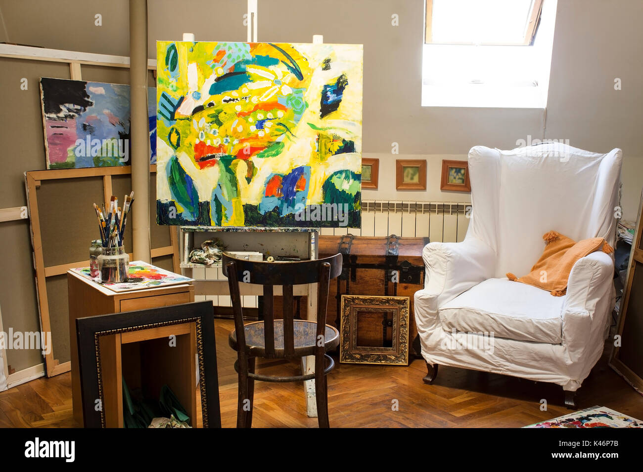 Art studio with paintings and painting equipment Stock Photo - Alamy