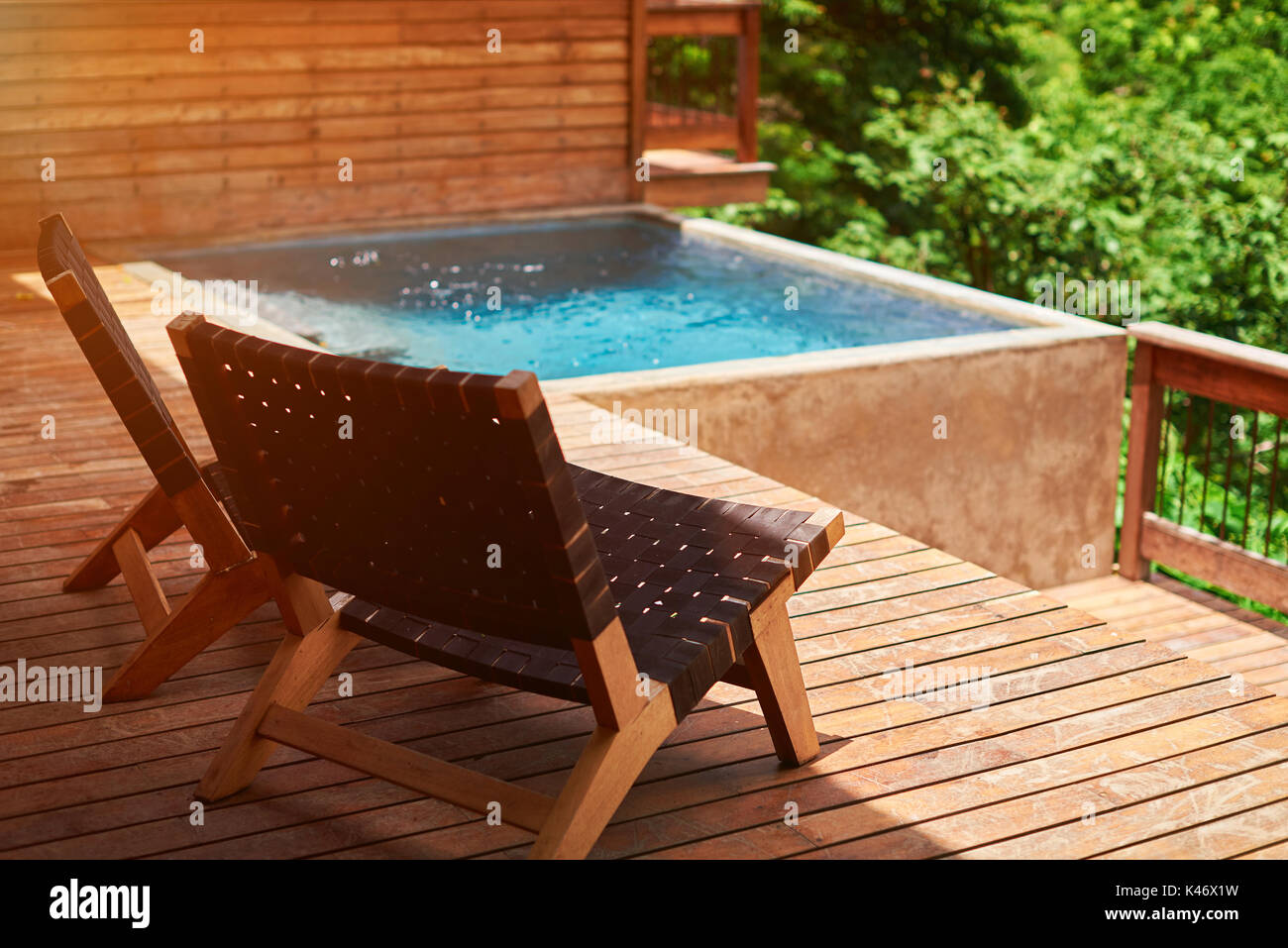Swimming pool in wooden terrace on sunny day. Vacation concept Stock ...