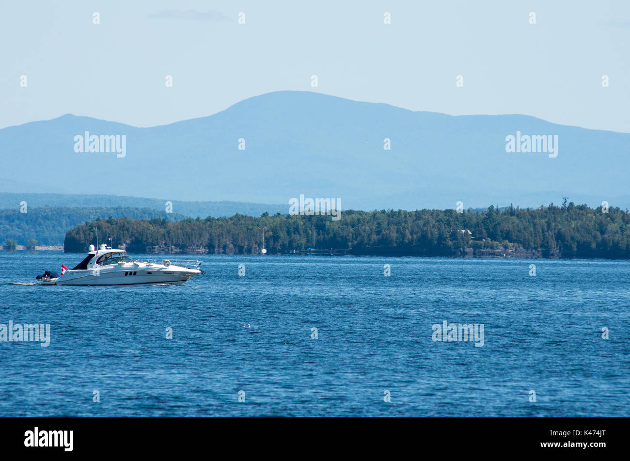 Large boat cruising on Lake Champlain with the Green Mountains of ...