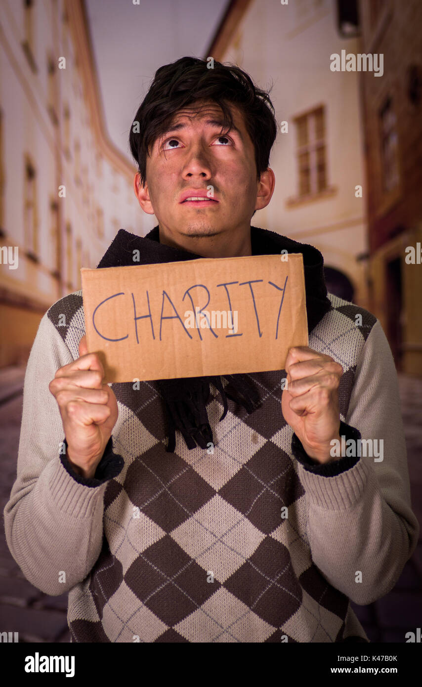 Close up of a homeless with cardboard description of charity, in a ...