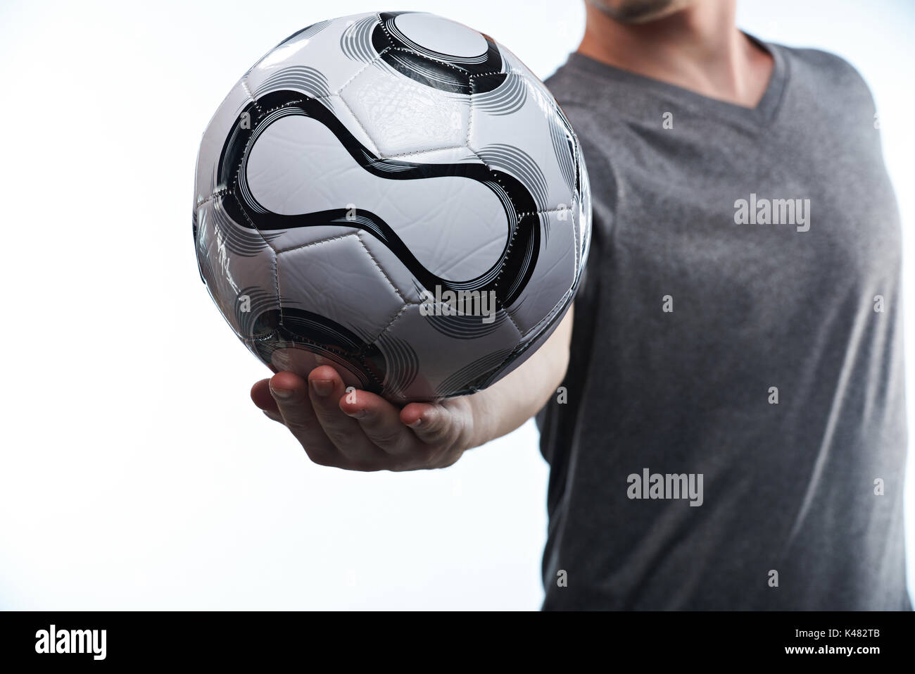 Modern football ball on player palm hand isolated on white background ...