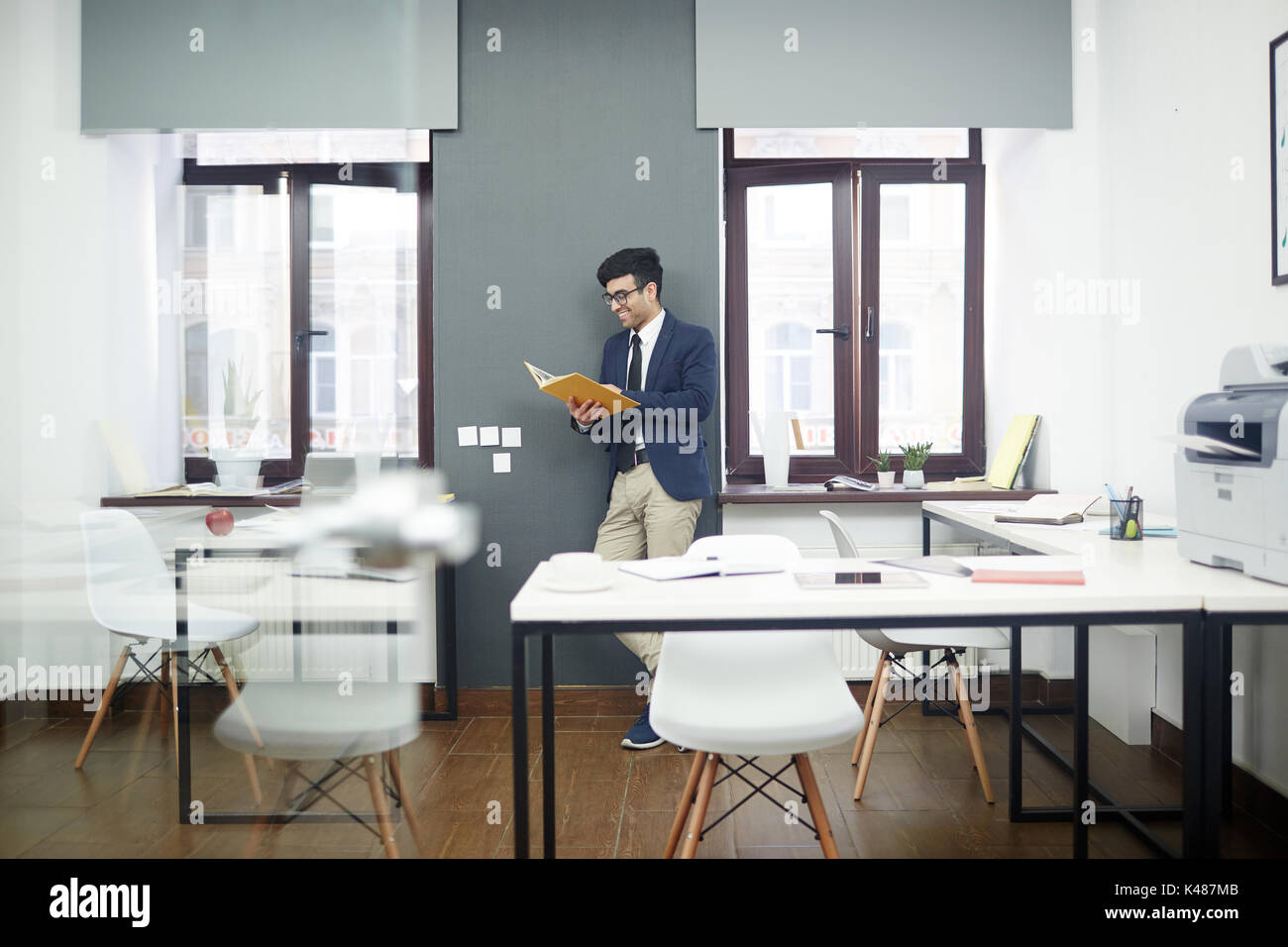 Manager reading book Stock Photo - Alamy