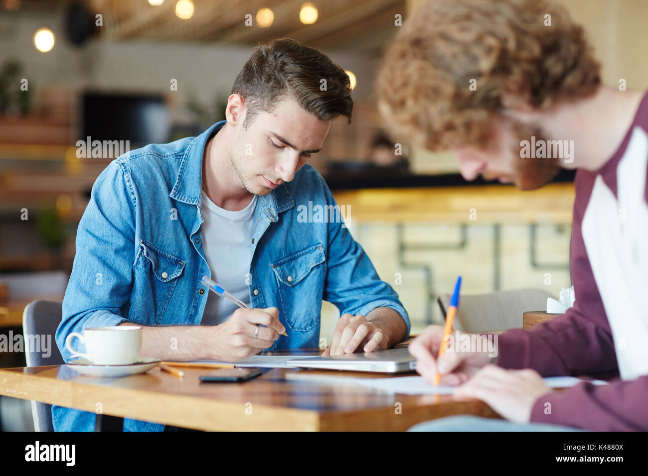Doing homework with friends hi-res stock photography and images - Alamy