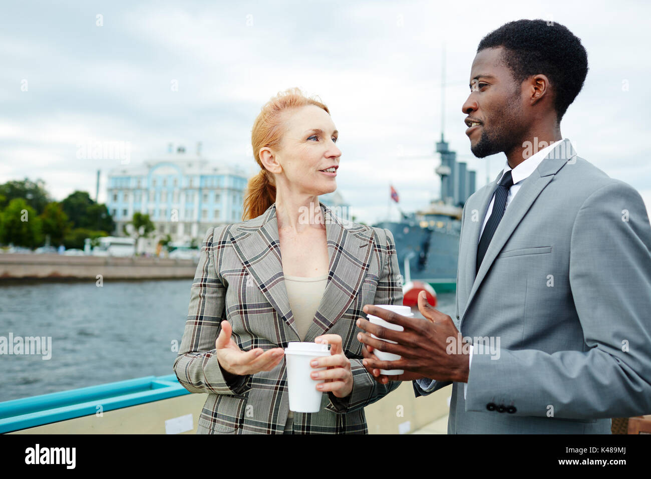 Conversation of colleagues Stock Photo - Alamy