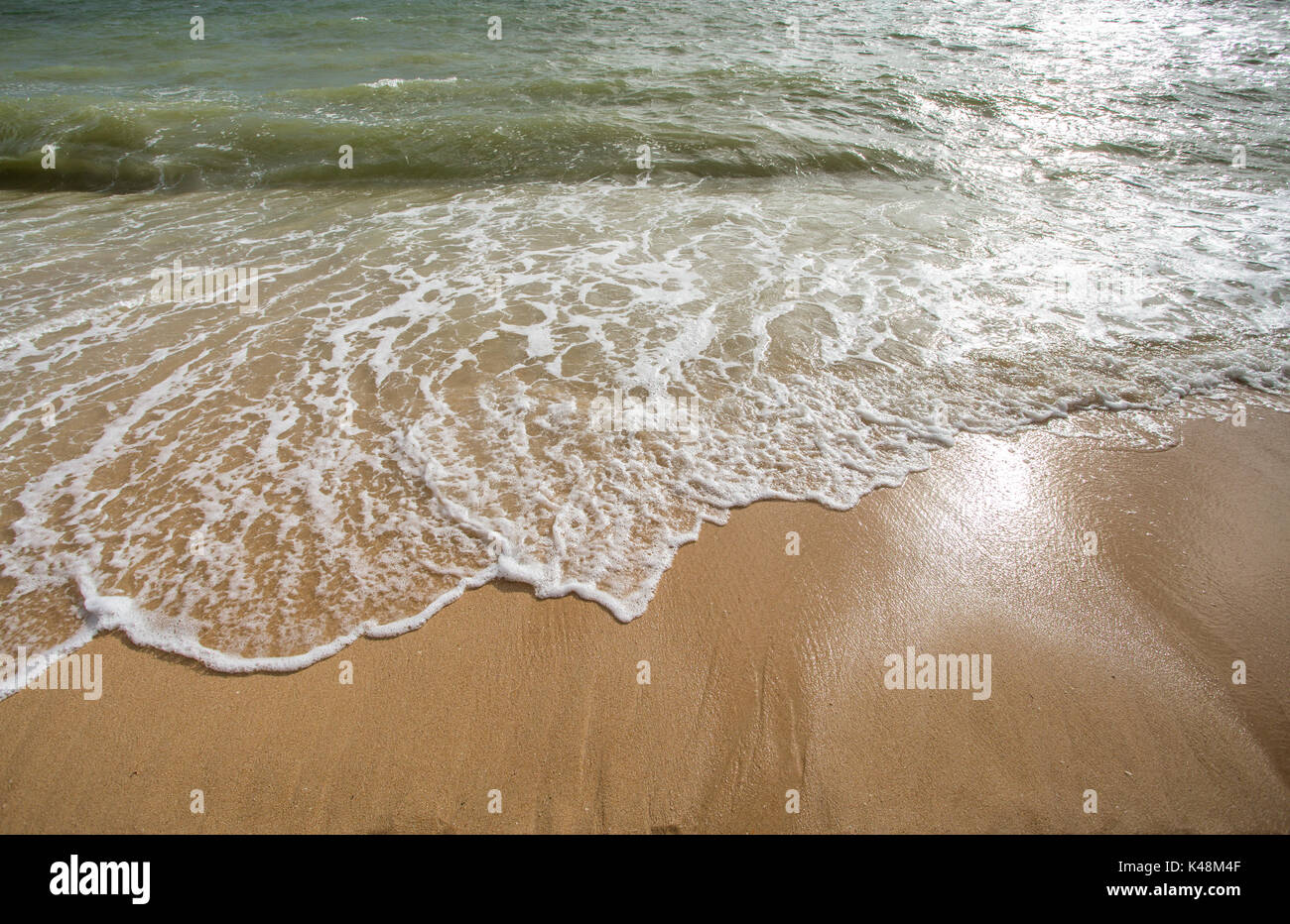 bubbles waves on the beach Stock Photo - Alamy