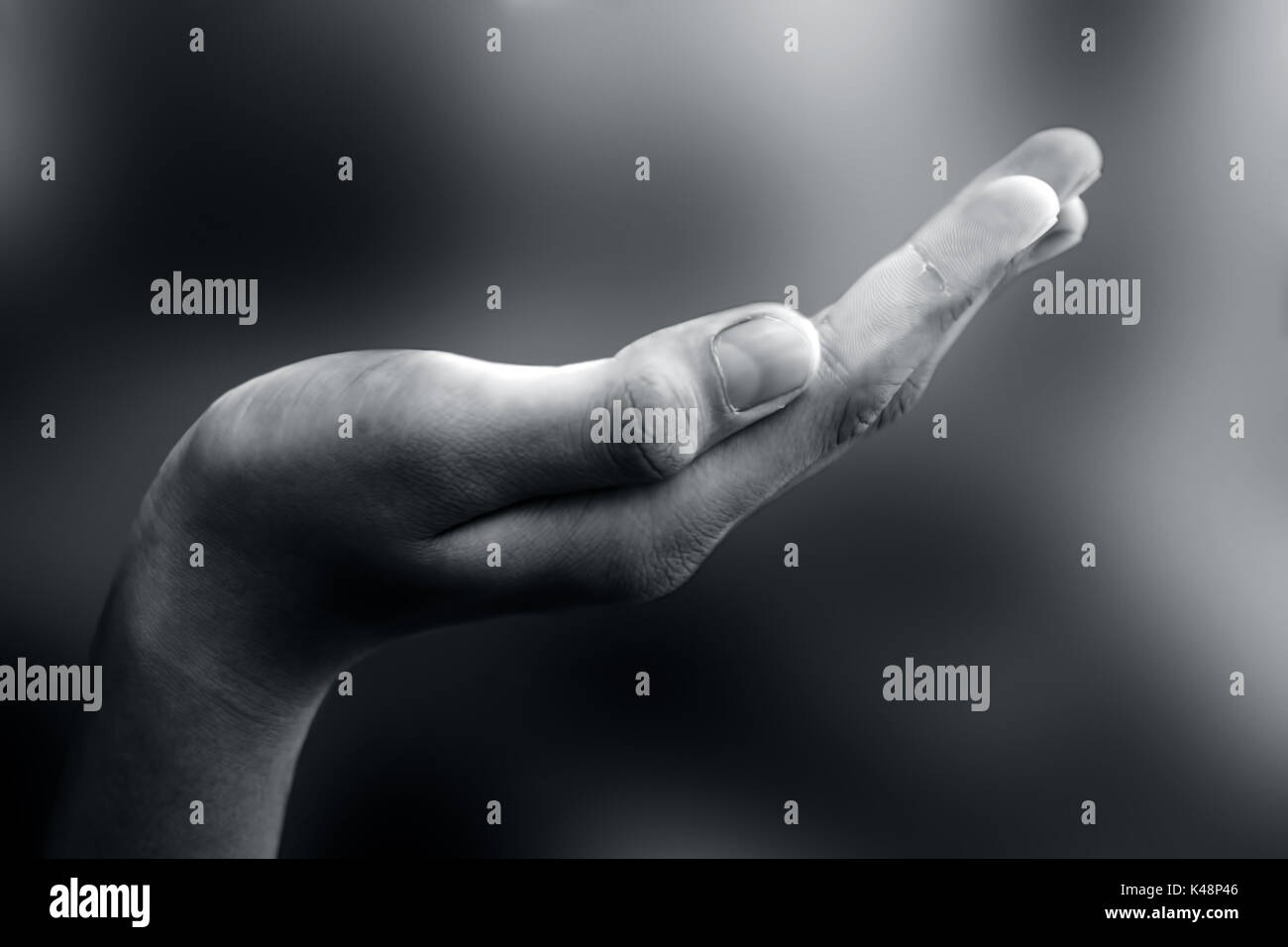 a hand shot in green background Stock Photo - Alamy