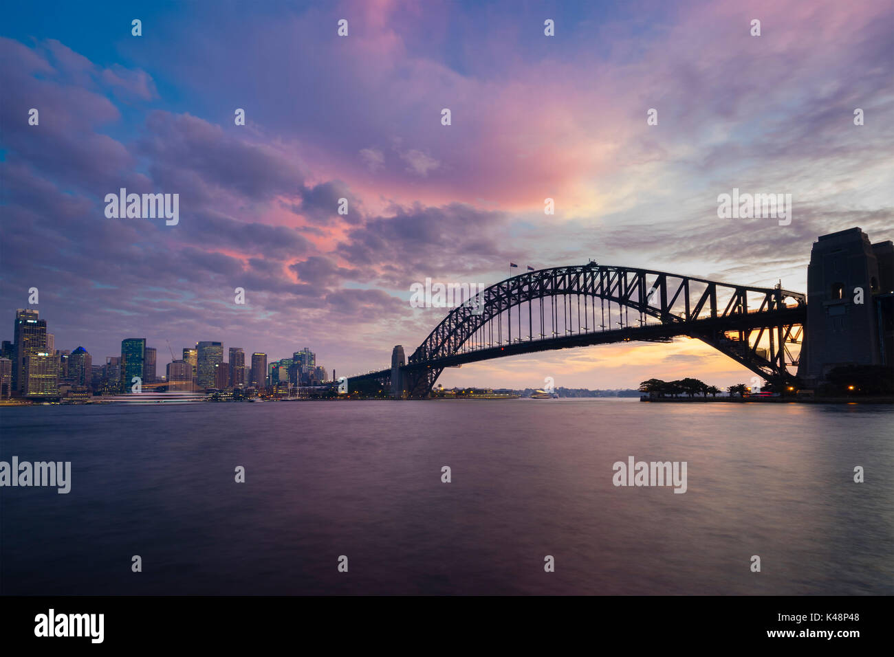 Sydney CBD and Harbour Bridge at sunset with colourful sky Stock Photo ...