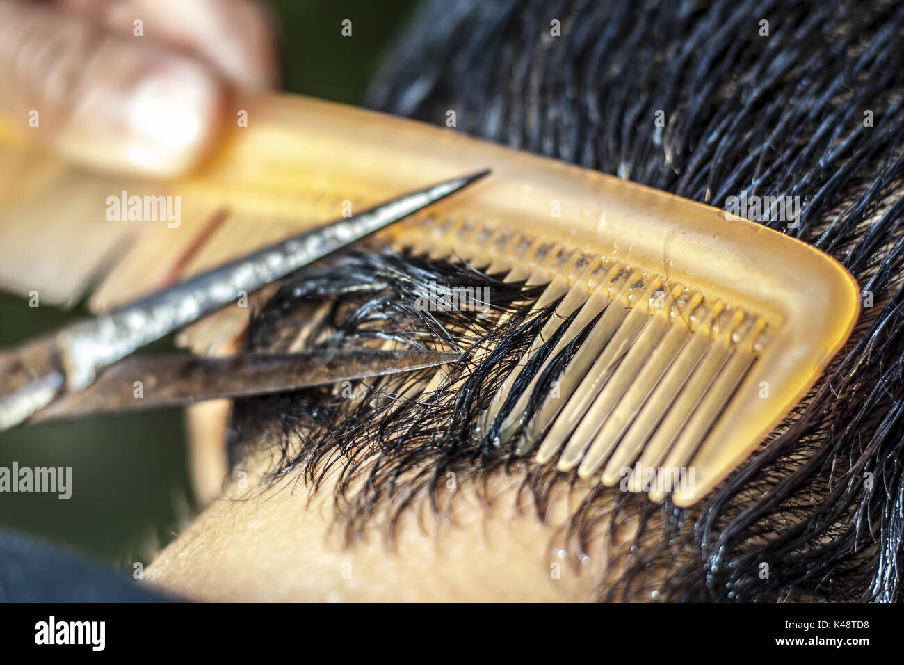 A hand doing hair cut Stock Photo - Alamy