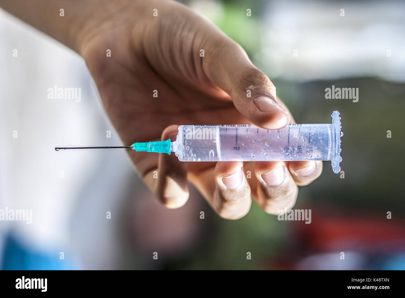 A hand holding an empty injection Stock Photo - Alamy