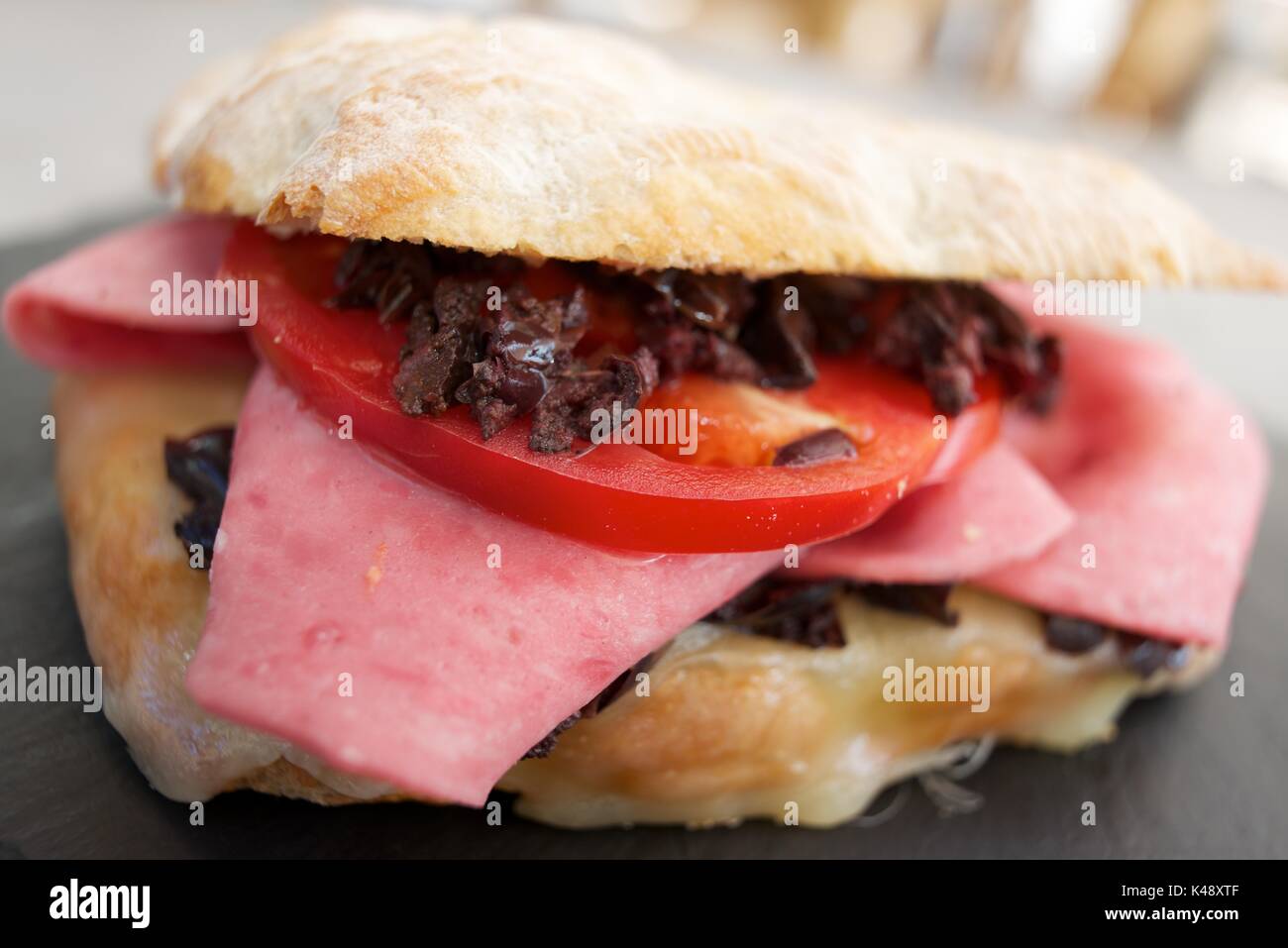 Mortadella sandwich, tomato and black olives Stock Photo - Alamy