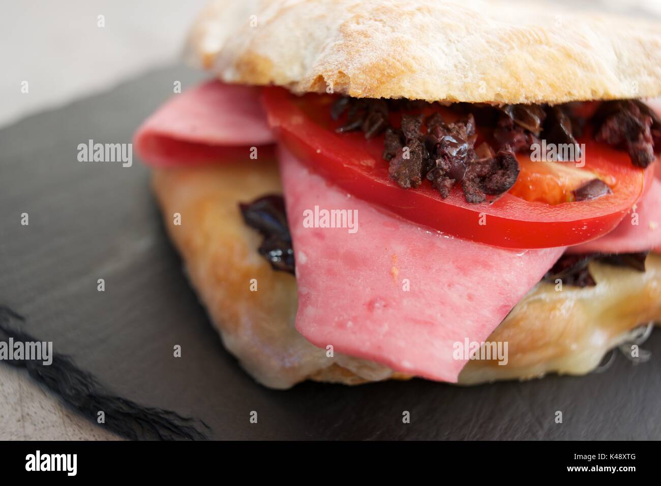 Mortadella sandwich, tomato and black olives Stock Photo - Alamy