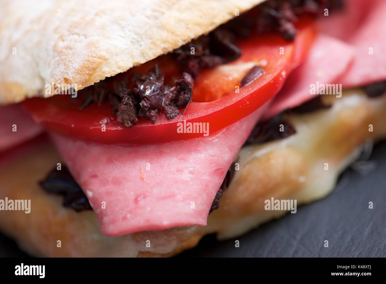 Mortadella sandwich, tomato and black olives Stock Photo - Alamy