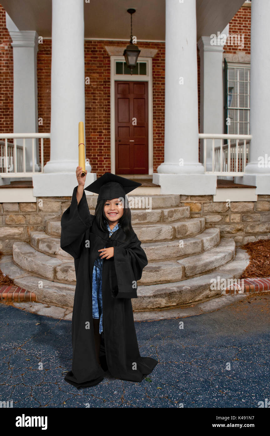 Little girl in her graduation robes or gown Stock Photo - Alamy