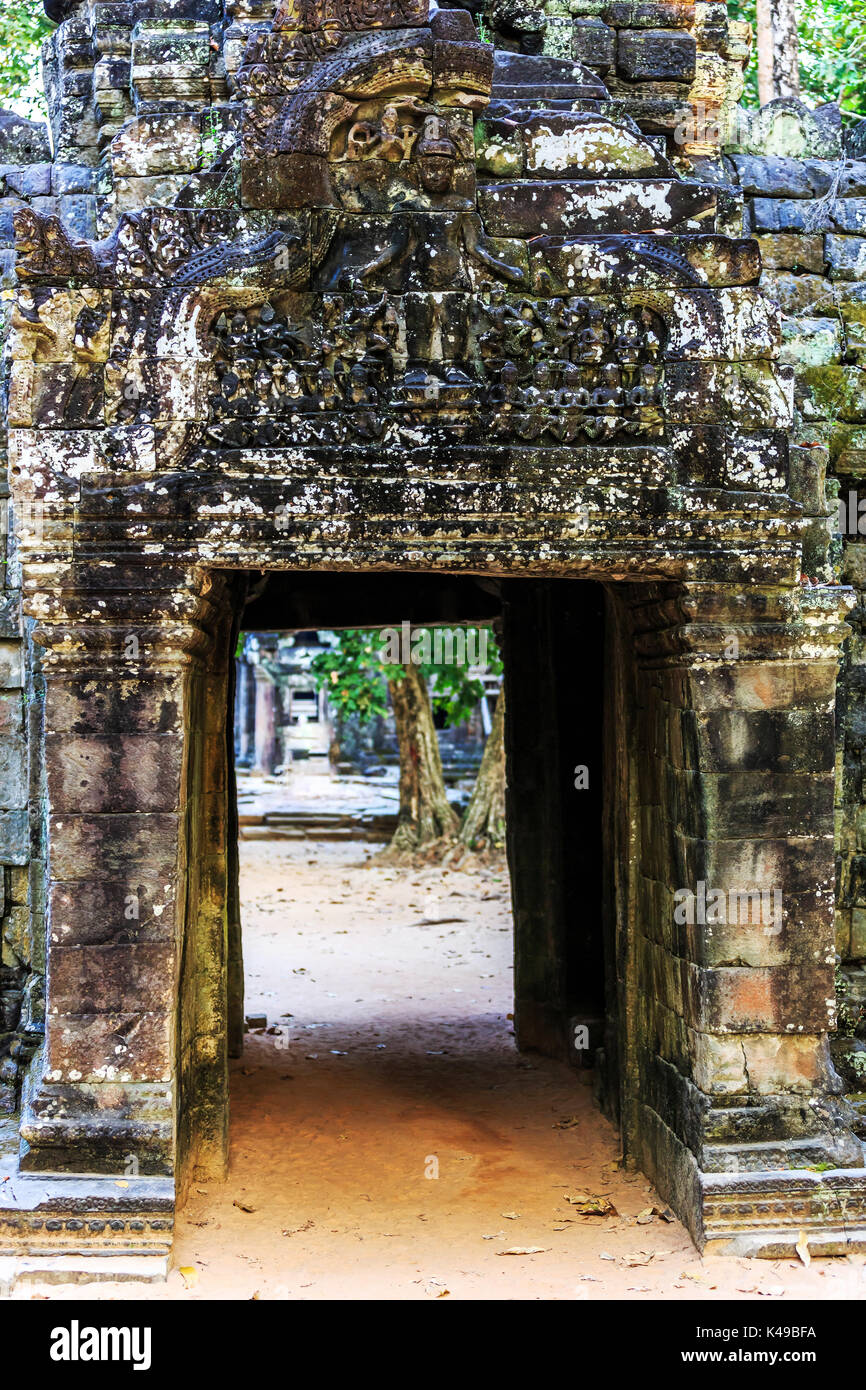 Ancient stone door in ruins of buddhist khmer temple near Siem Reap ...