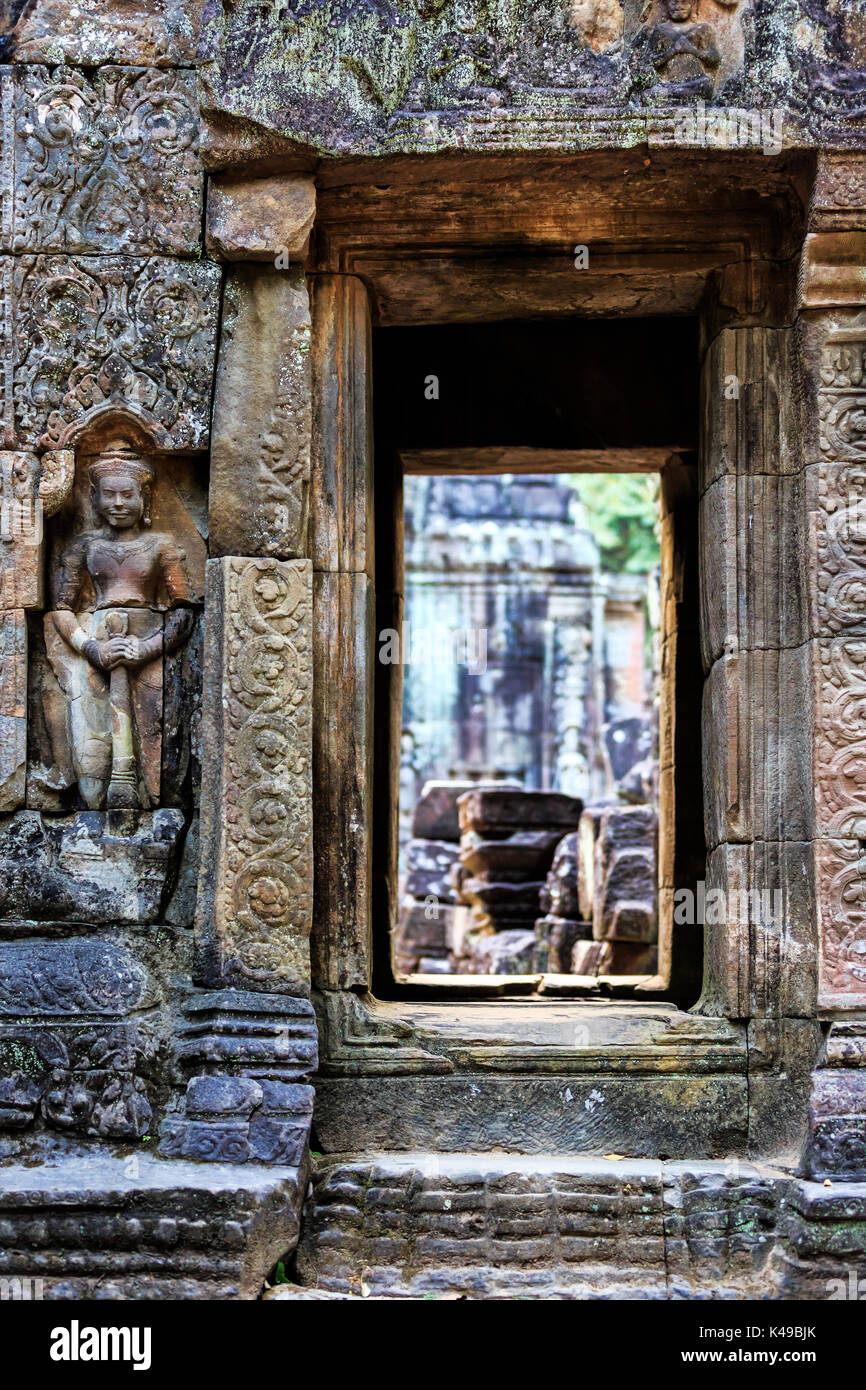 Ancient stone door in ruins of buddhist khmer temple near Siem Reap ...