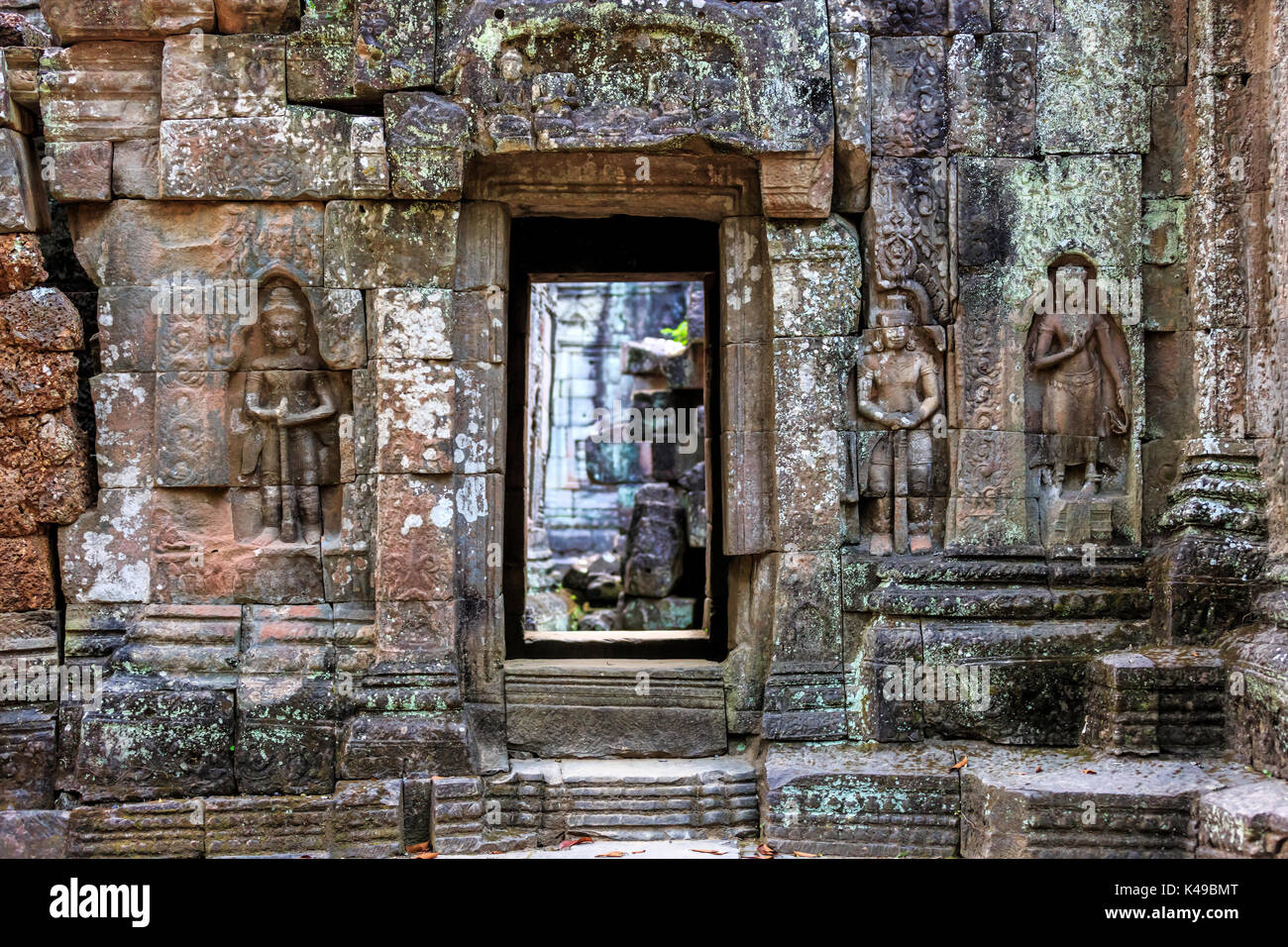 Ancient stone door in ruins of buddhist khmer temple near Siem Reap ...