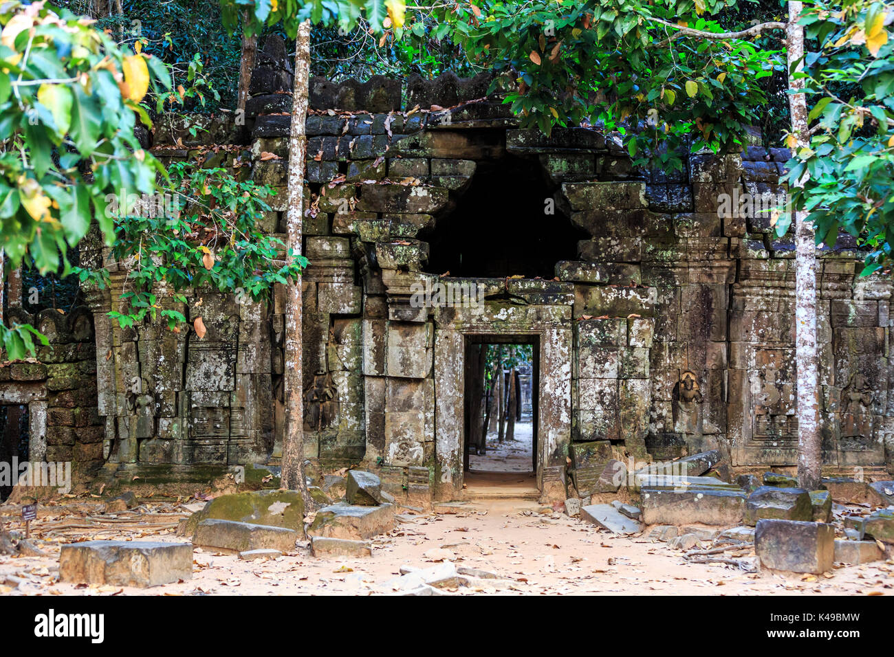 Ancient stone door in ruins of buddhist khmer temple near Siem Reap ...