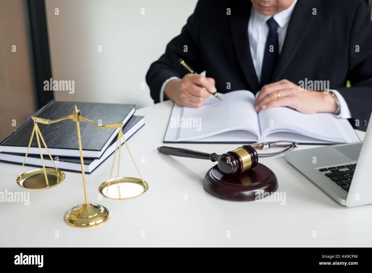 lawyer hand writes the document in court (justice, law) with sounding ...